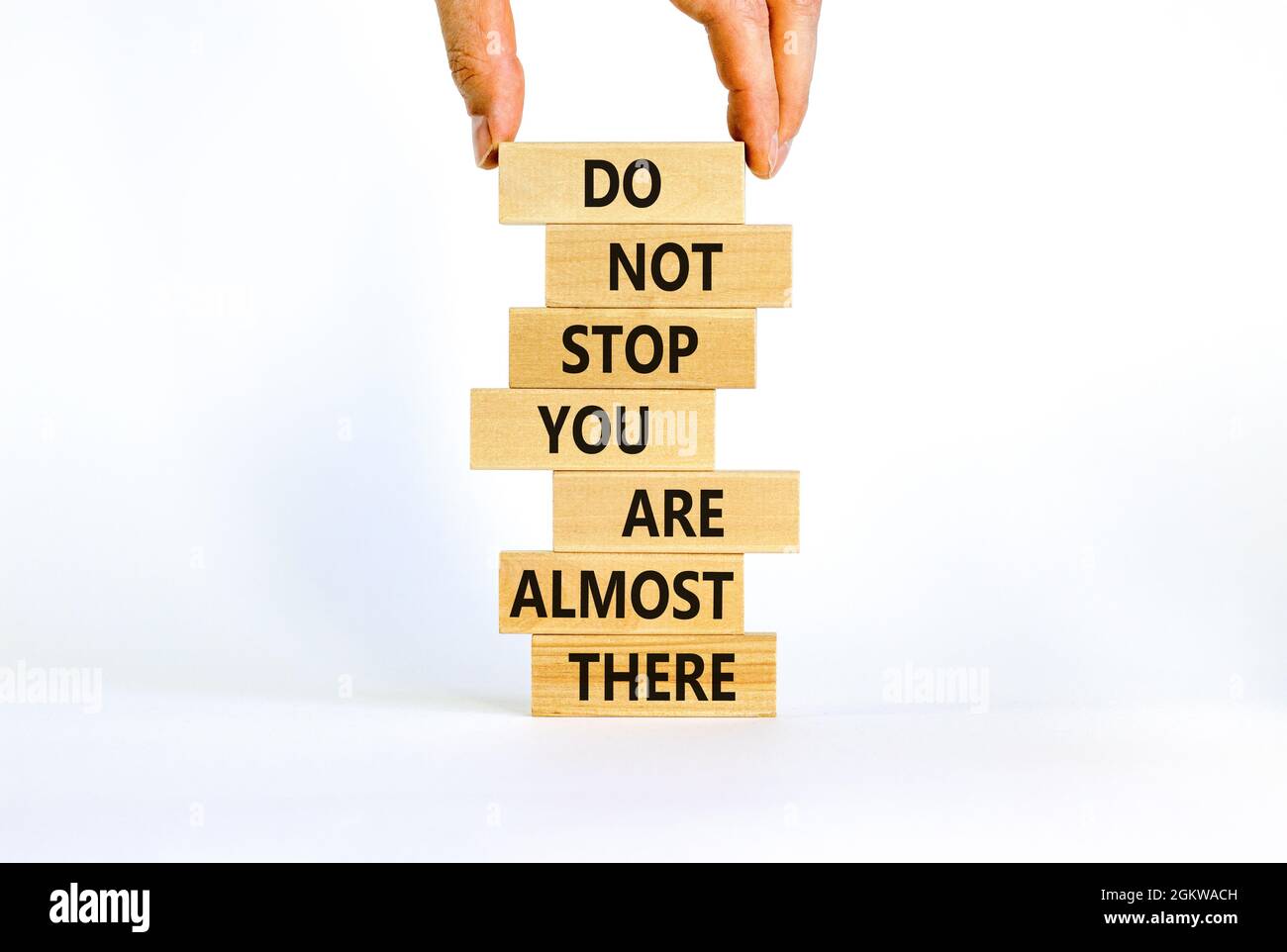 You are almost there symbol. Wooden blocks with words 'do not stop you ...