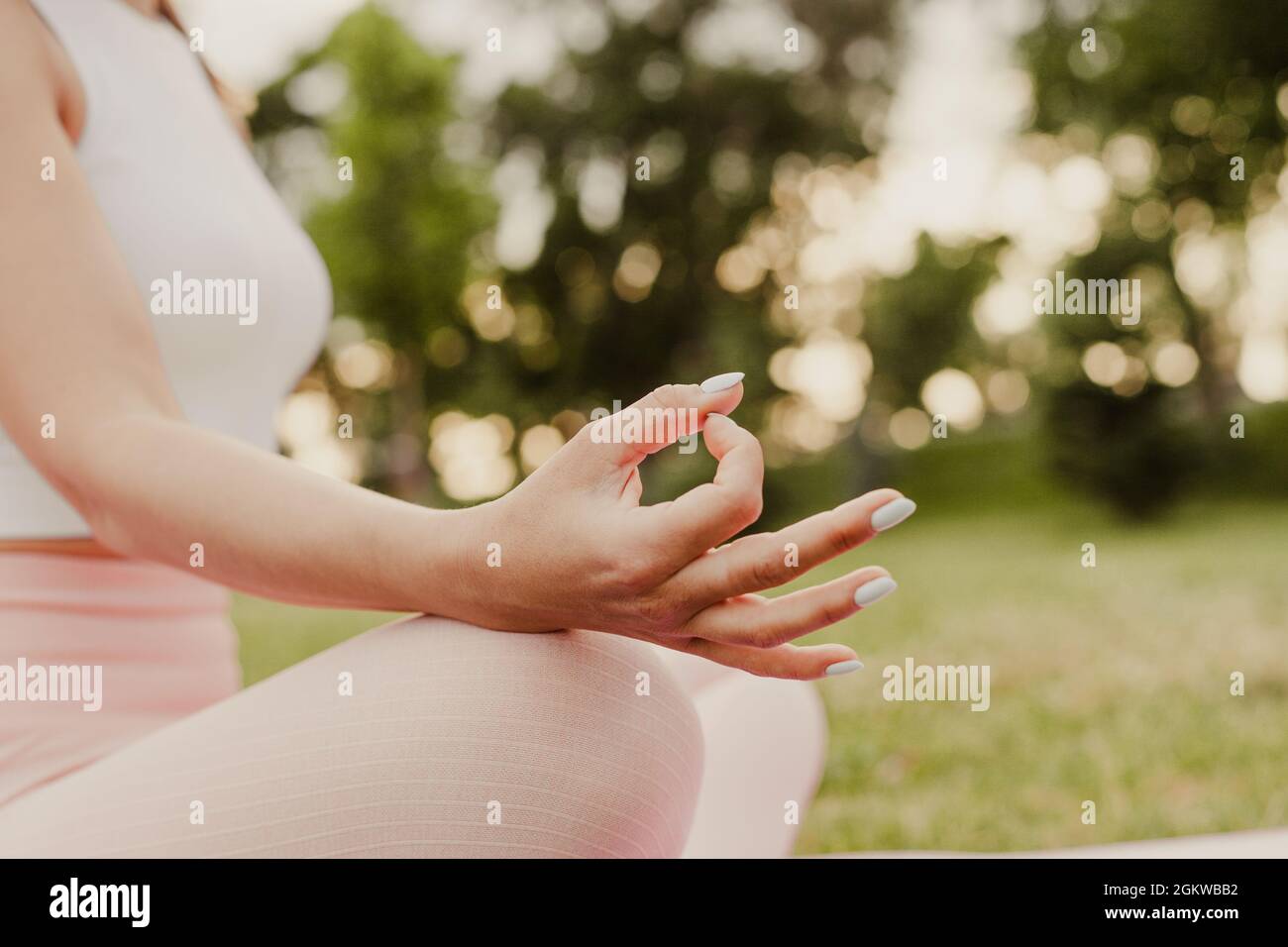 blurred close - up of woman legs sitting in lotus position and ...