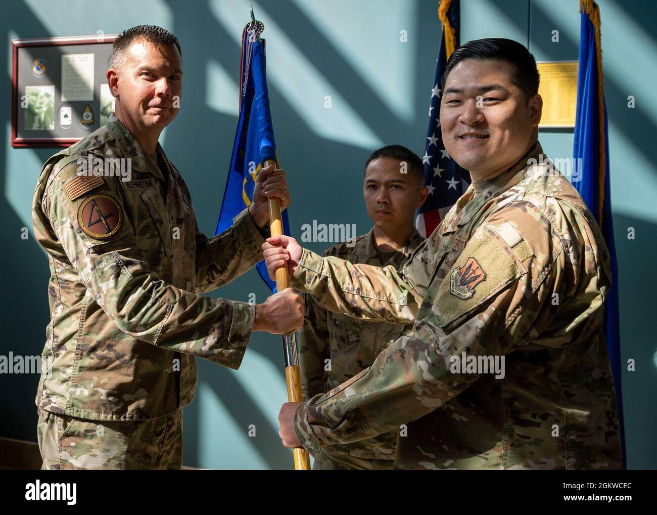 Maj. Samuel Han, right, 4th Comptroller Squadron commander, receives ...