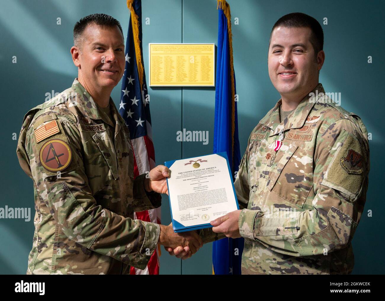 Col. Kurt Helphinstine, left, 4th Fighter Wing commander, presents Maj ...