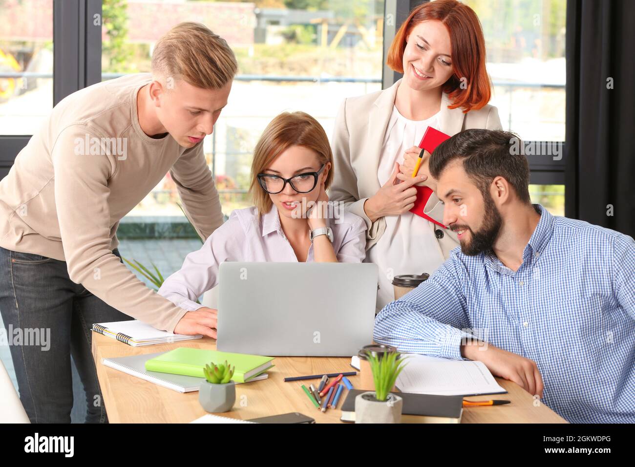 Group of young students with laptop studying indoors Stock Photo - Alamy