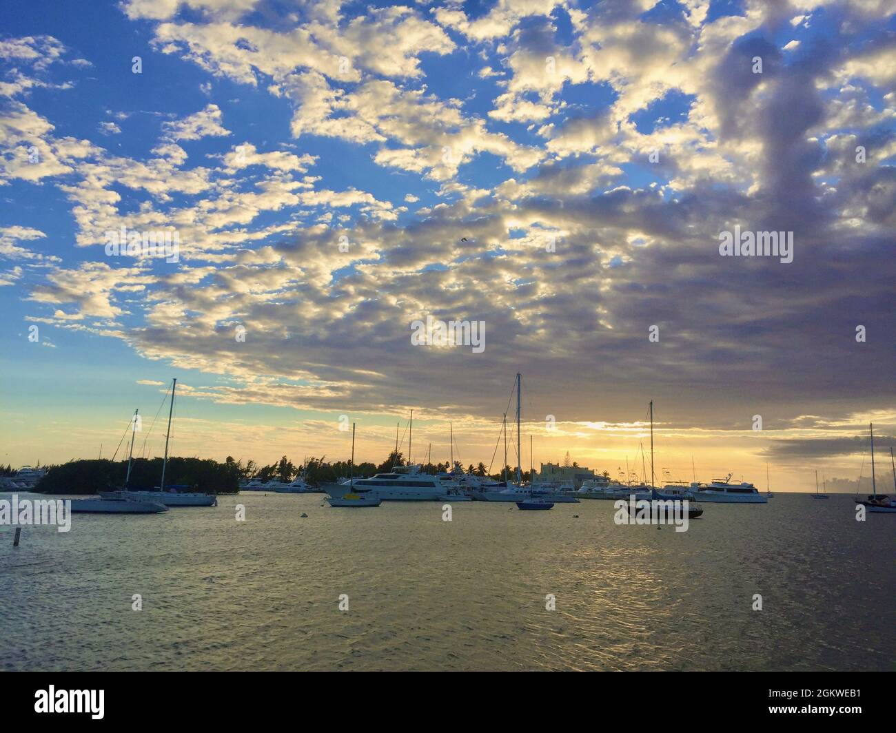 Landscape of boats and ships at a port under a cloudy sky and sunlight ...