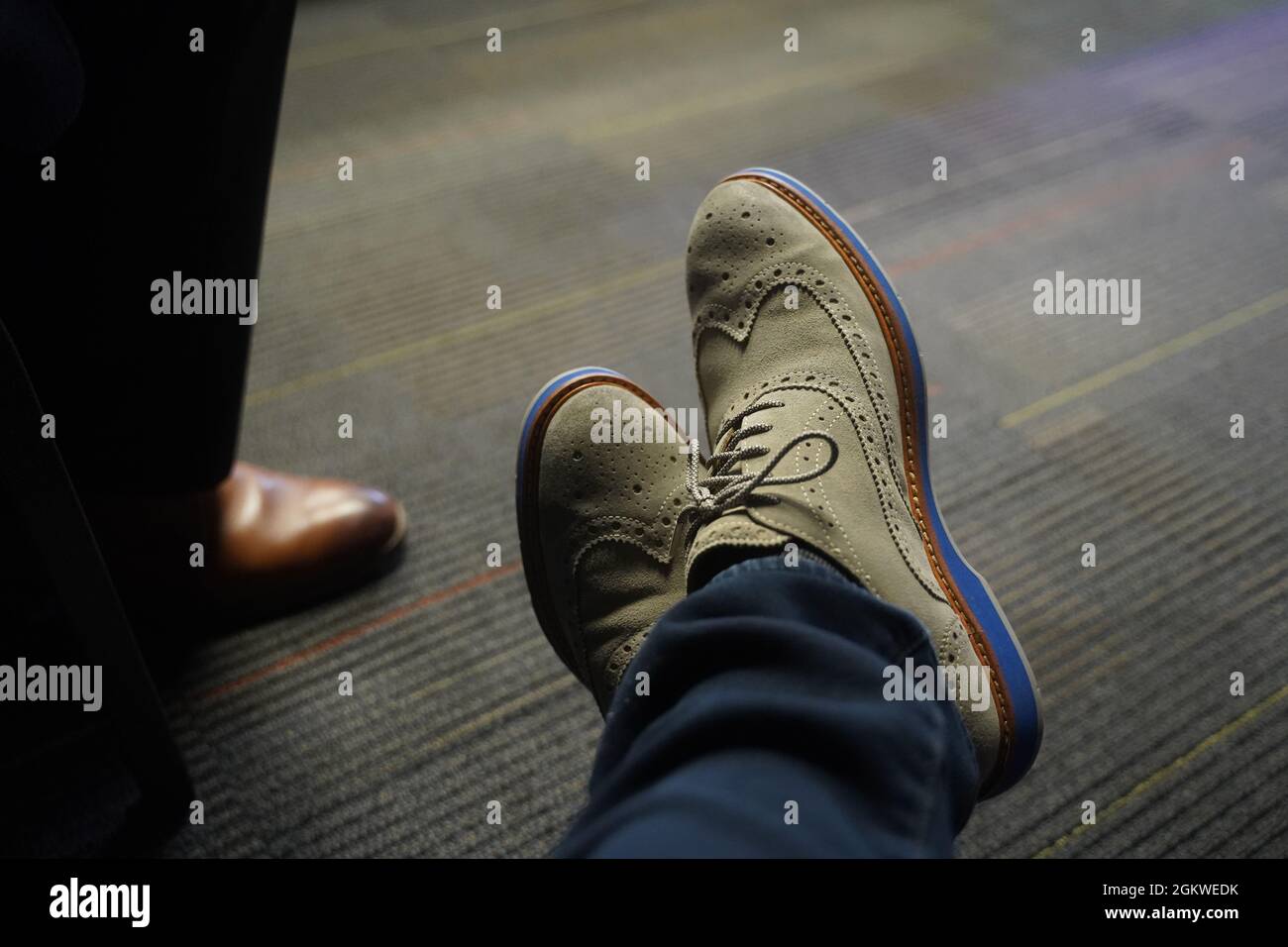 Man legs crossed wearing green shoes Stock Photo - Alamy
