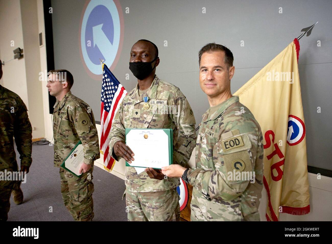 Spc. Yregis Kpohonnou, 1st Theater Sustainment Command, is awarded the ...
