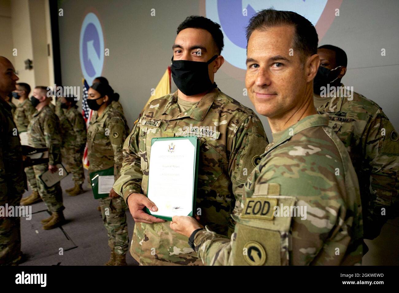 Cpl. Giovanni Marquez, 1st Theater Sustainment Command, is presented a ...