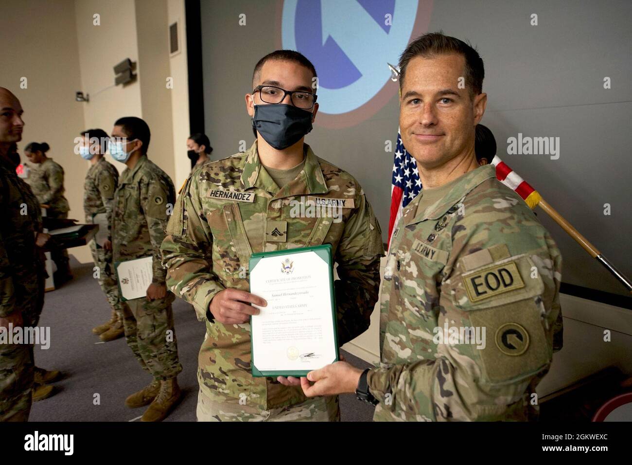 Cpl. Samuel Hernandez, 1st Theater Sustainment Command, is presented a ...