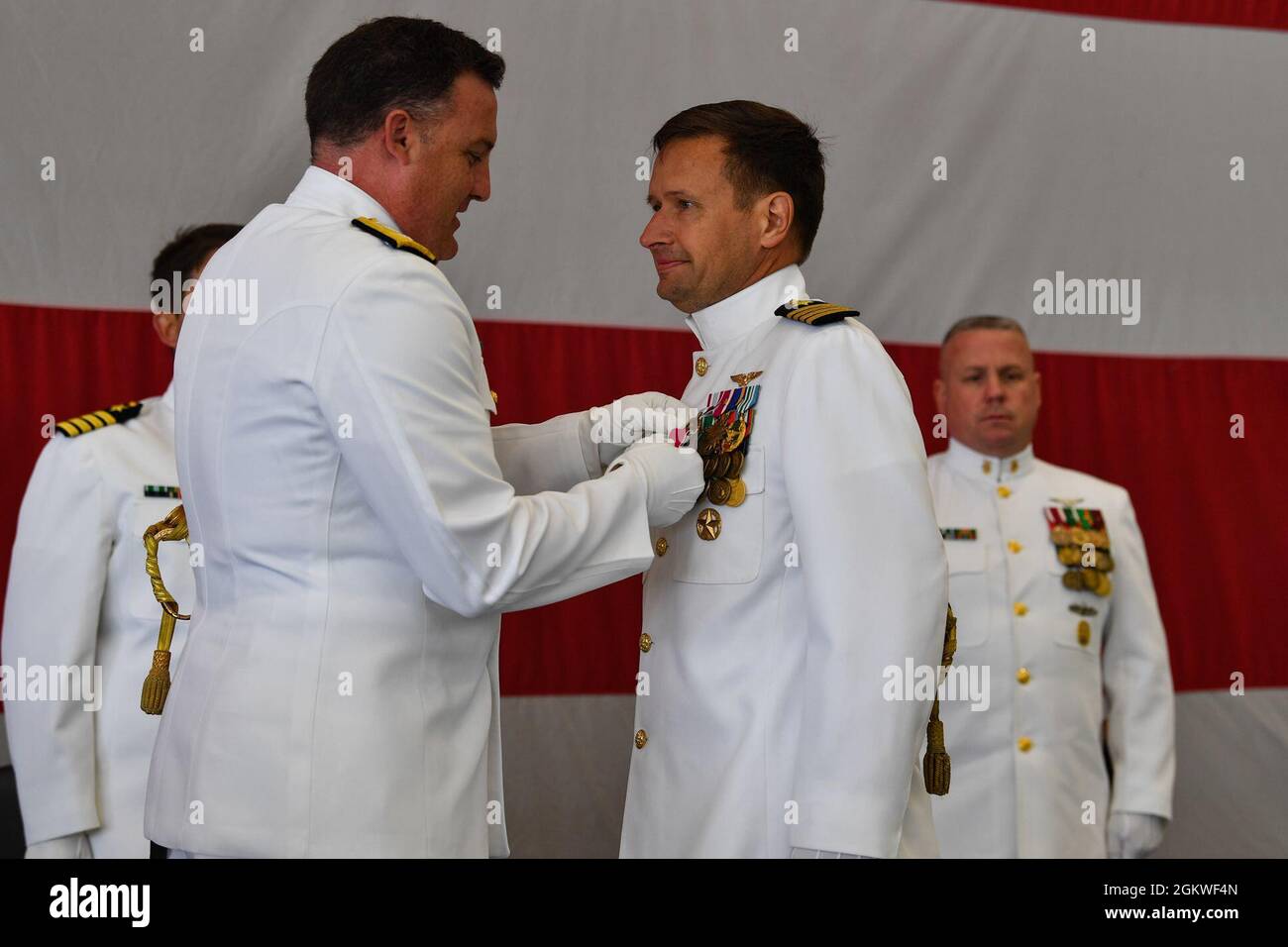 Rear Adm. Brad Collins, Commander Navy Region Northwest, awards Capt ...