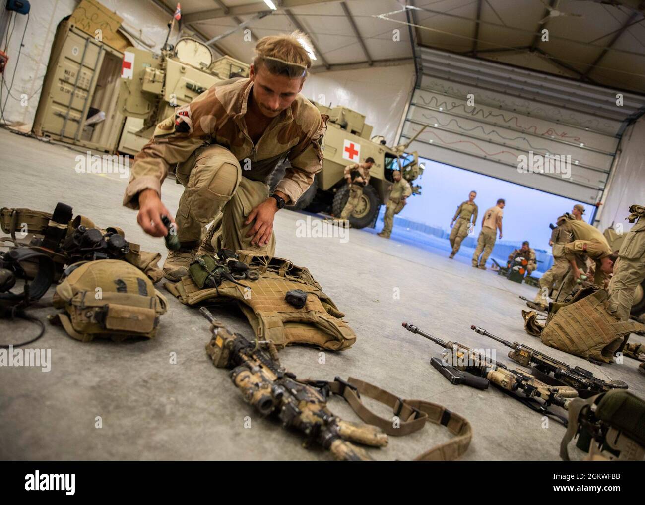A Norwegian Soldier from Task Force Viking, runs equipment checks ...