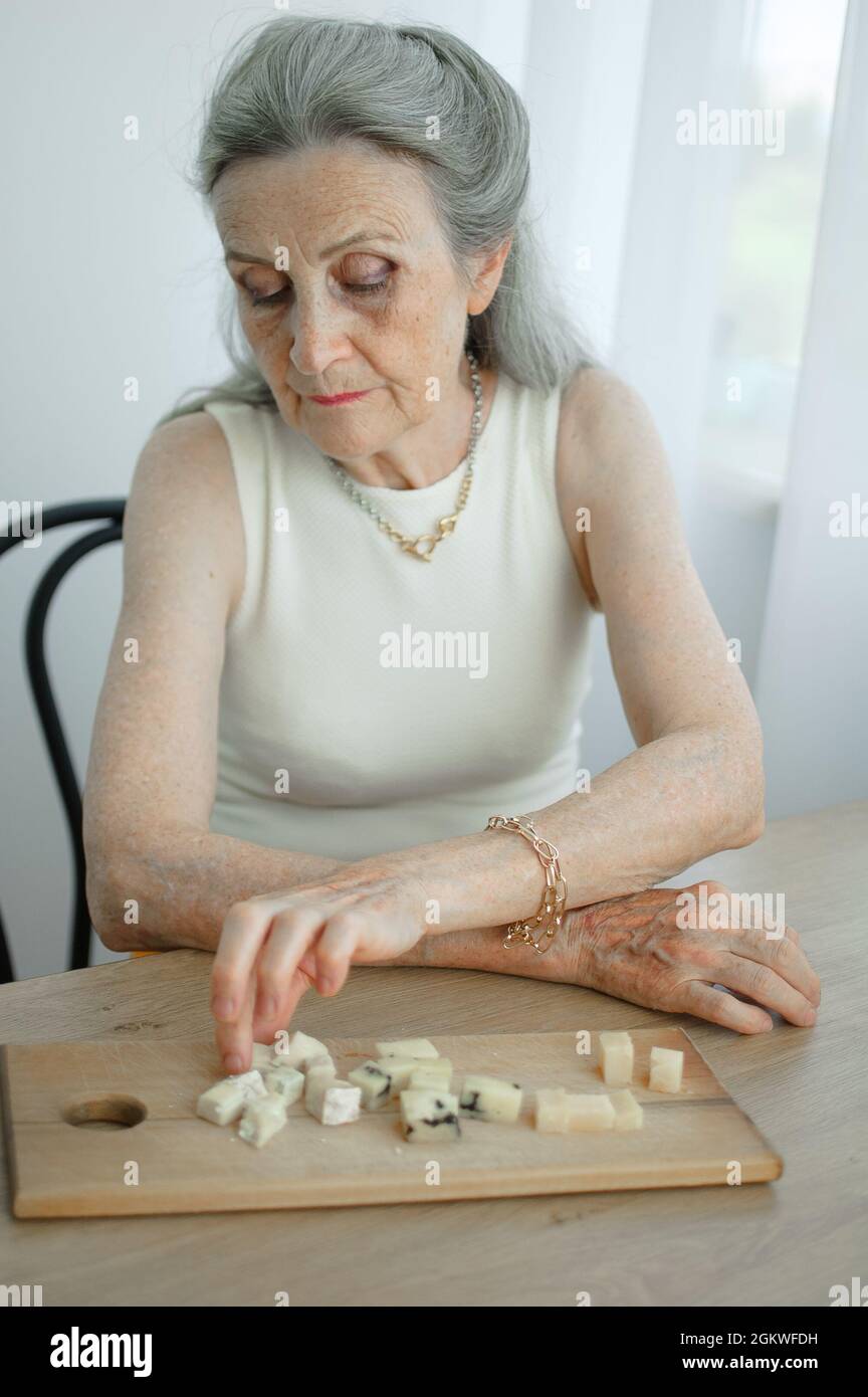 Portrait of beautiful old grandmother with grey hair and face with ...