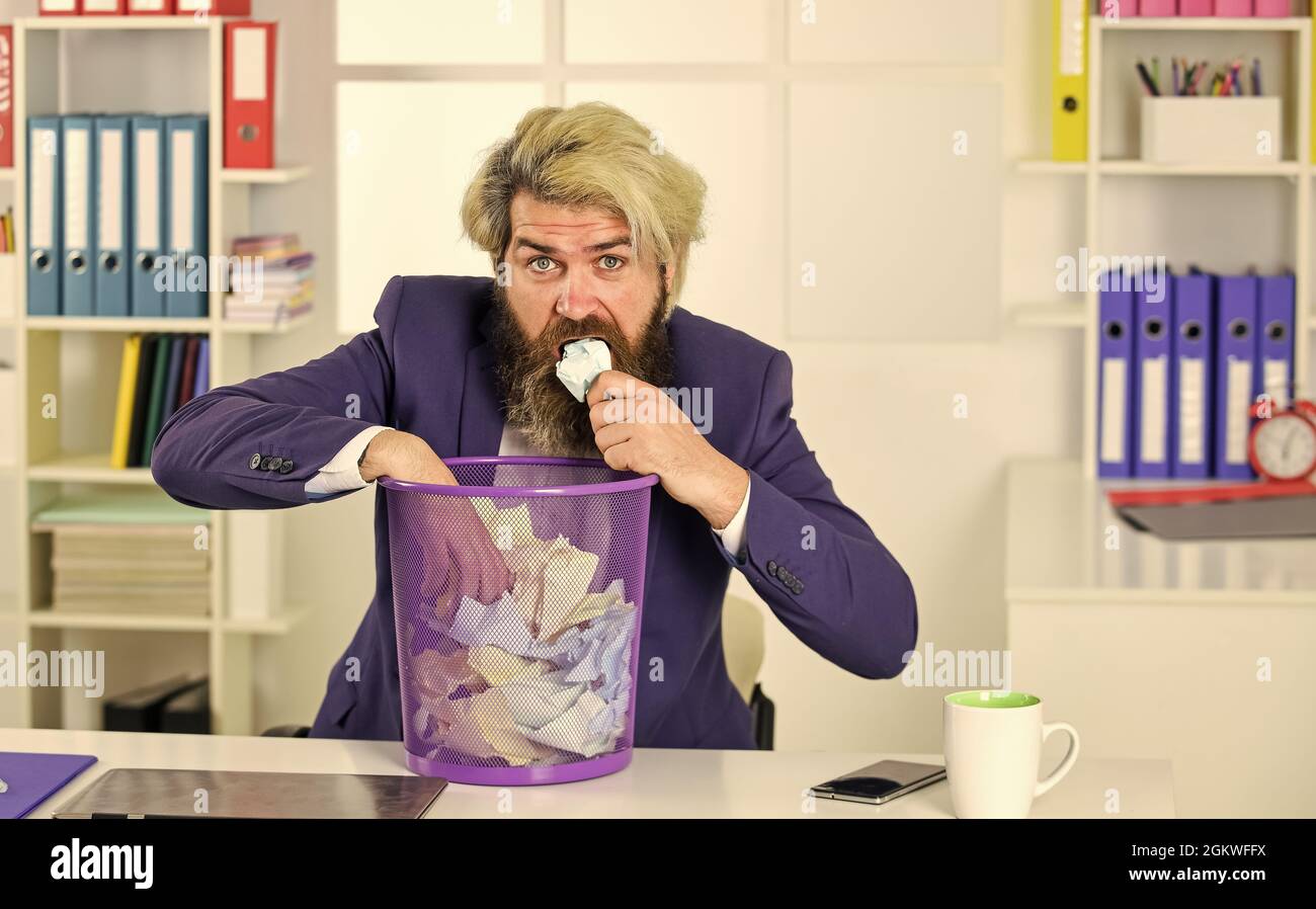 hungry man eat paper. man search crimpled paper in basket. ceo in messy ...