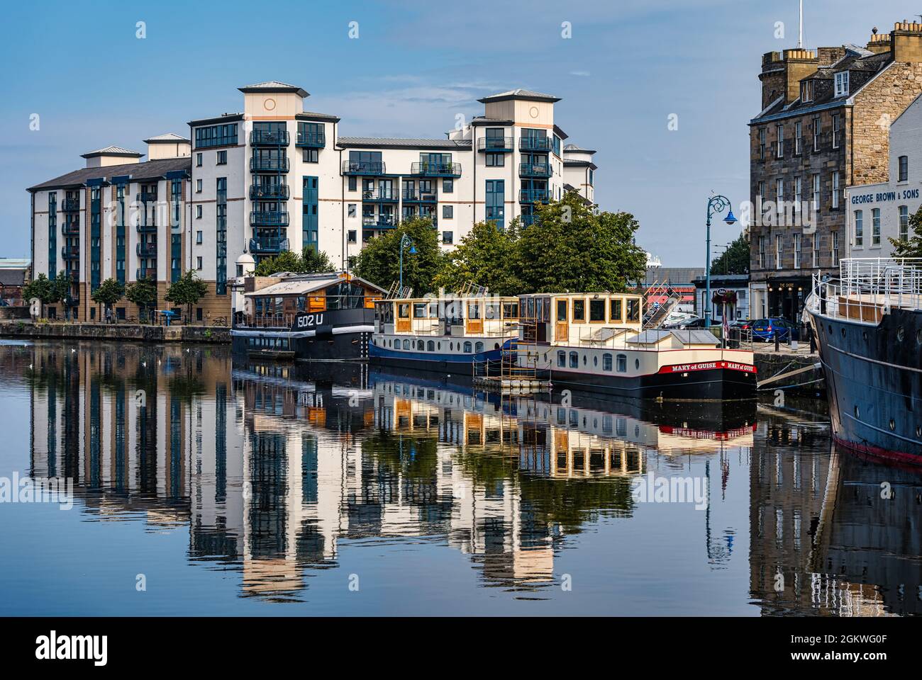 Queen's Quay modern riverside apartment block with moored river barges ...