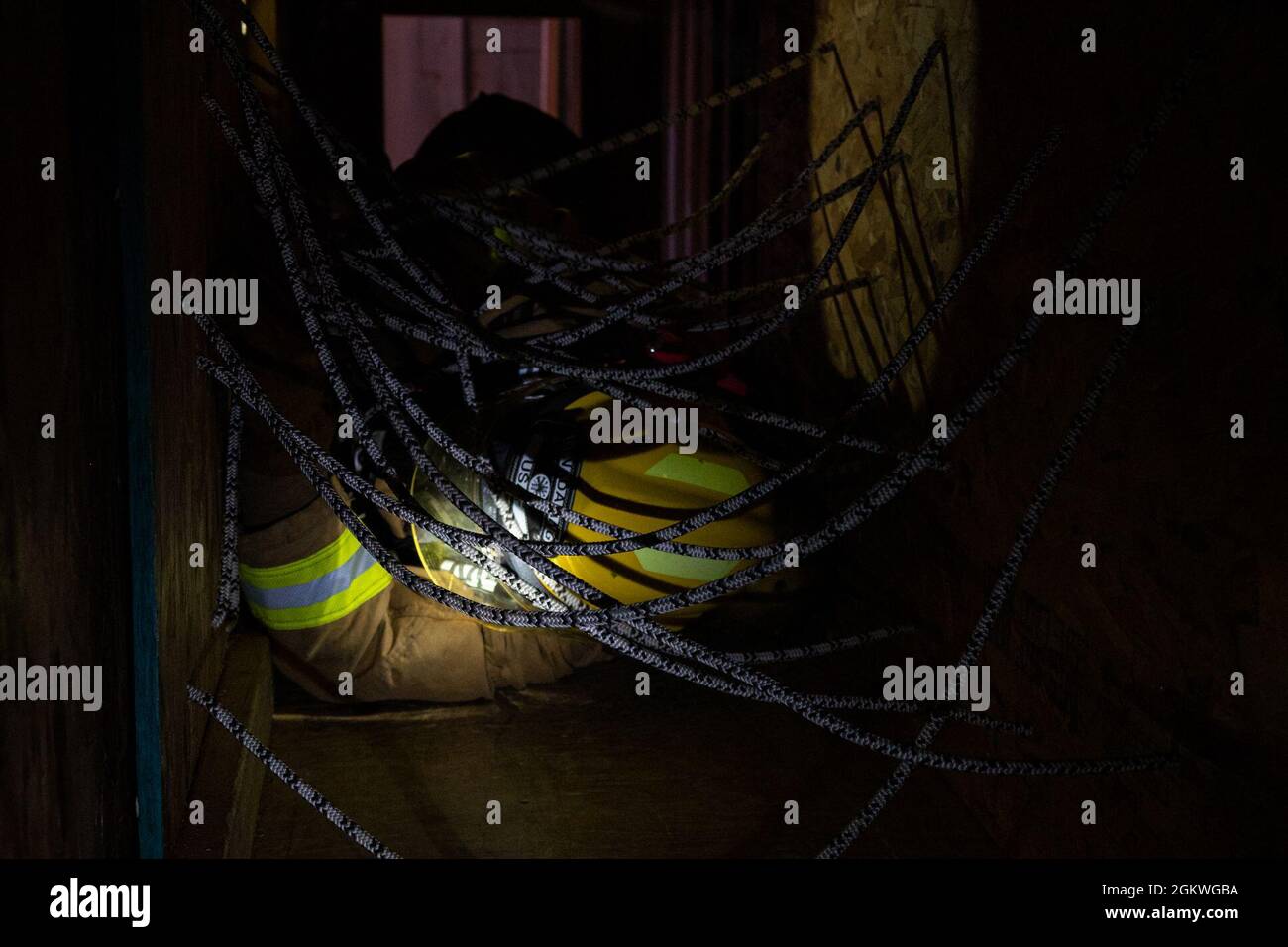 A 152nd Civil Engineer Squadron fire protection specialist maneuvers ...