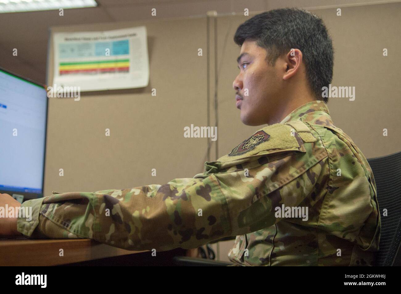 U.S. Air Force Airman 1st Class Isaac Dayag assists personnel in the ...
