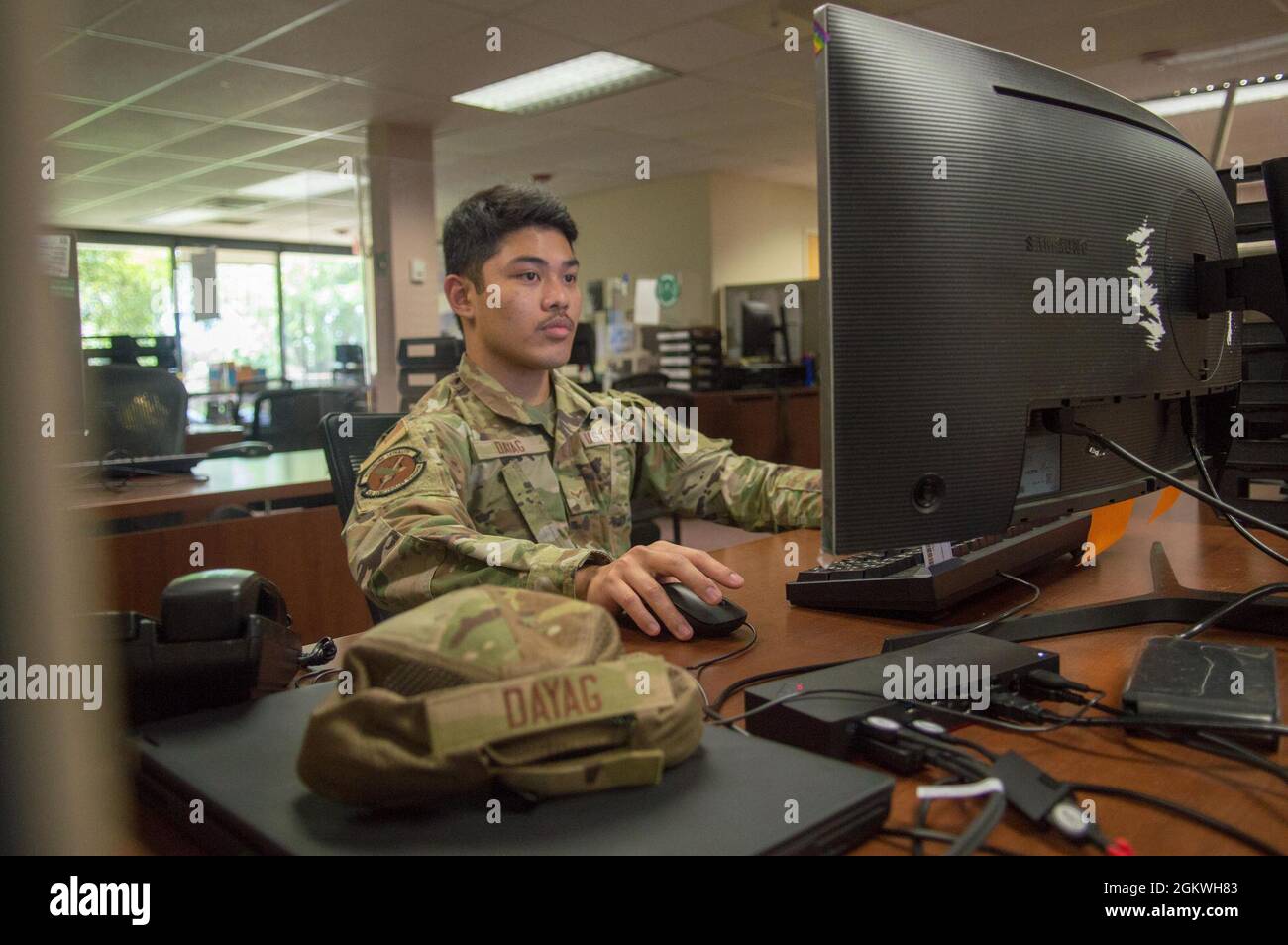 U.S. Air Force Airman 1st Class Isaac Dayag assists personnel in the ...