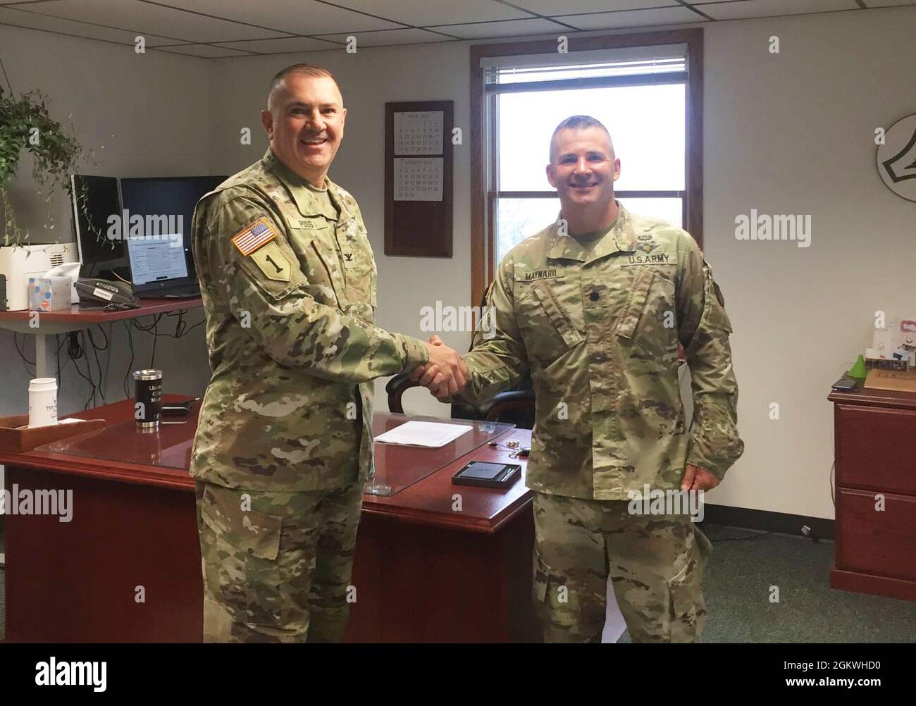 Garrison Commander Col. Michael Poss (left) welcomes incoming Garrison ...