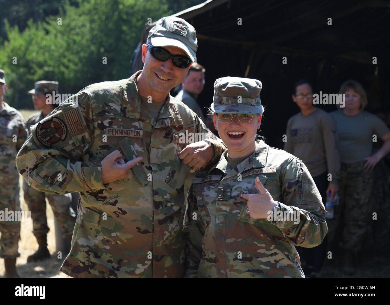 Maj. Gen. Jeffrey Pennington, 4th Air Force commander, and Airman Basic Averi Houck, one of the ...