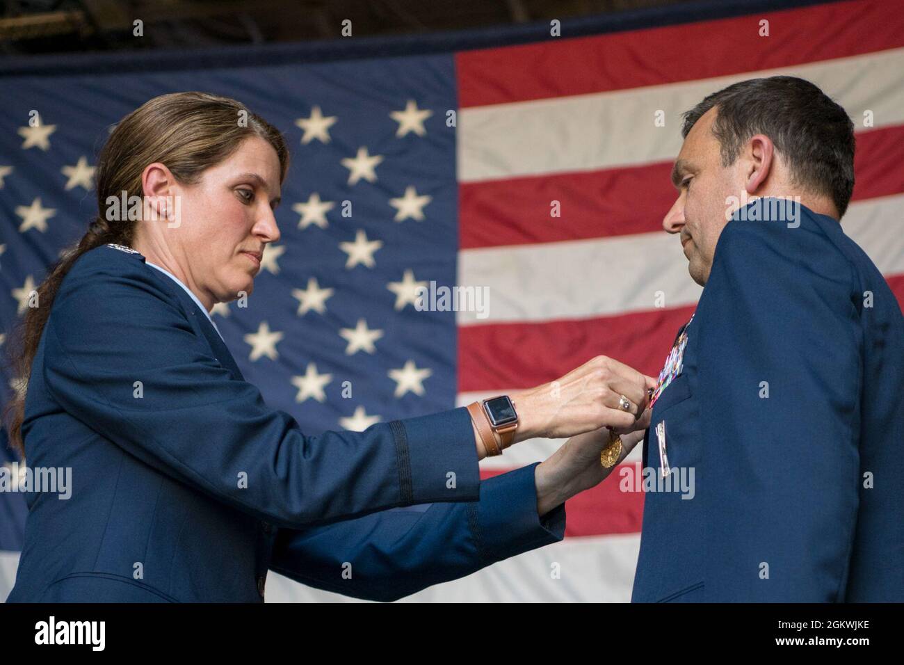Col. Erin Cook Commander of the 349th Maintnance Group places a pin on ...
