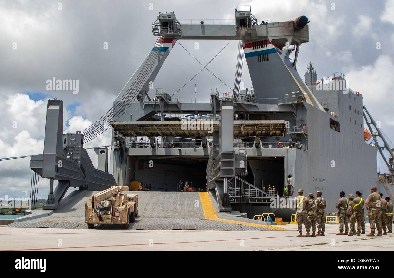 U.S. Army Soldiers observe as military vehicles are being downloaded ...