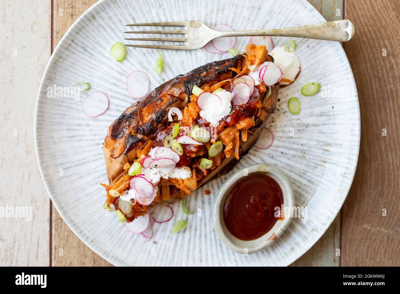 Baked sweet potato with barbeque jackfruit Stock Photo - Alamy