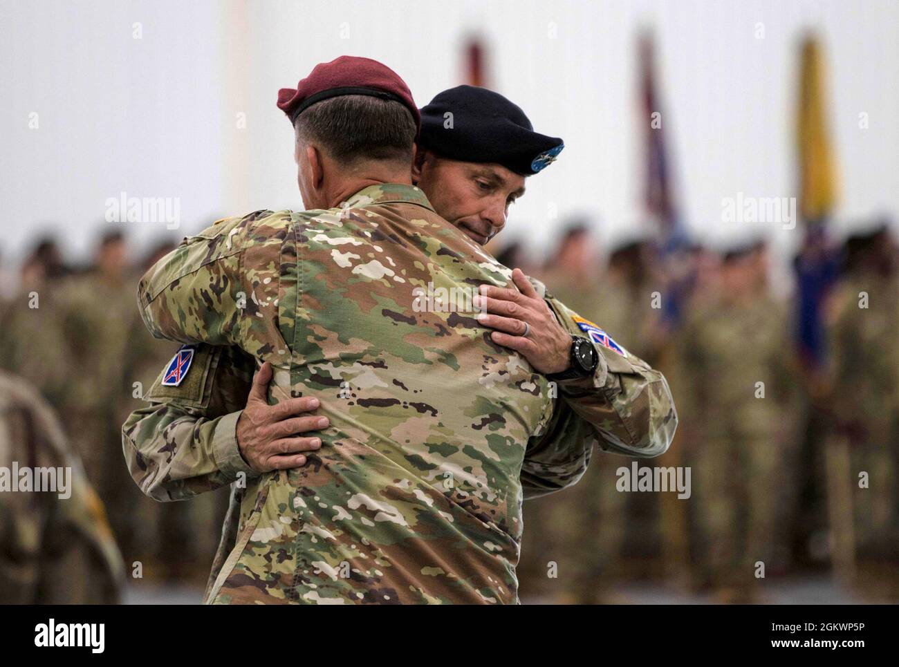 Maj. Gen. Brian Mennes embraces Lt. Gen. Michael Kurilla before a ...
