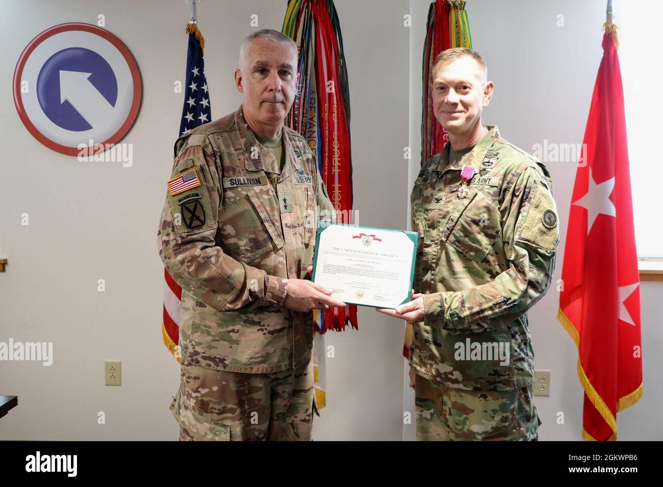 Maj. Gen. John P. Sullivan, commanding general, 1st Theater Sustainment Command, presents the ...