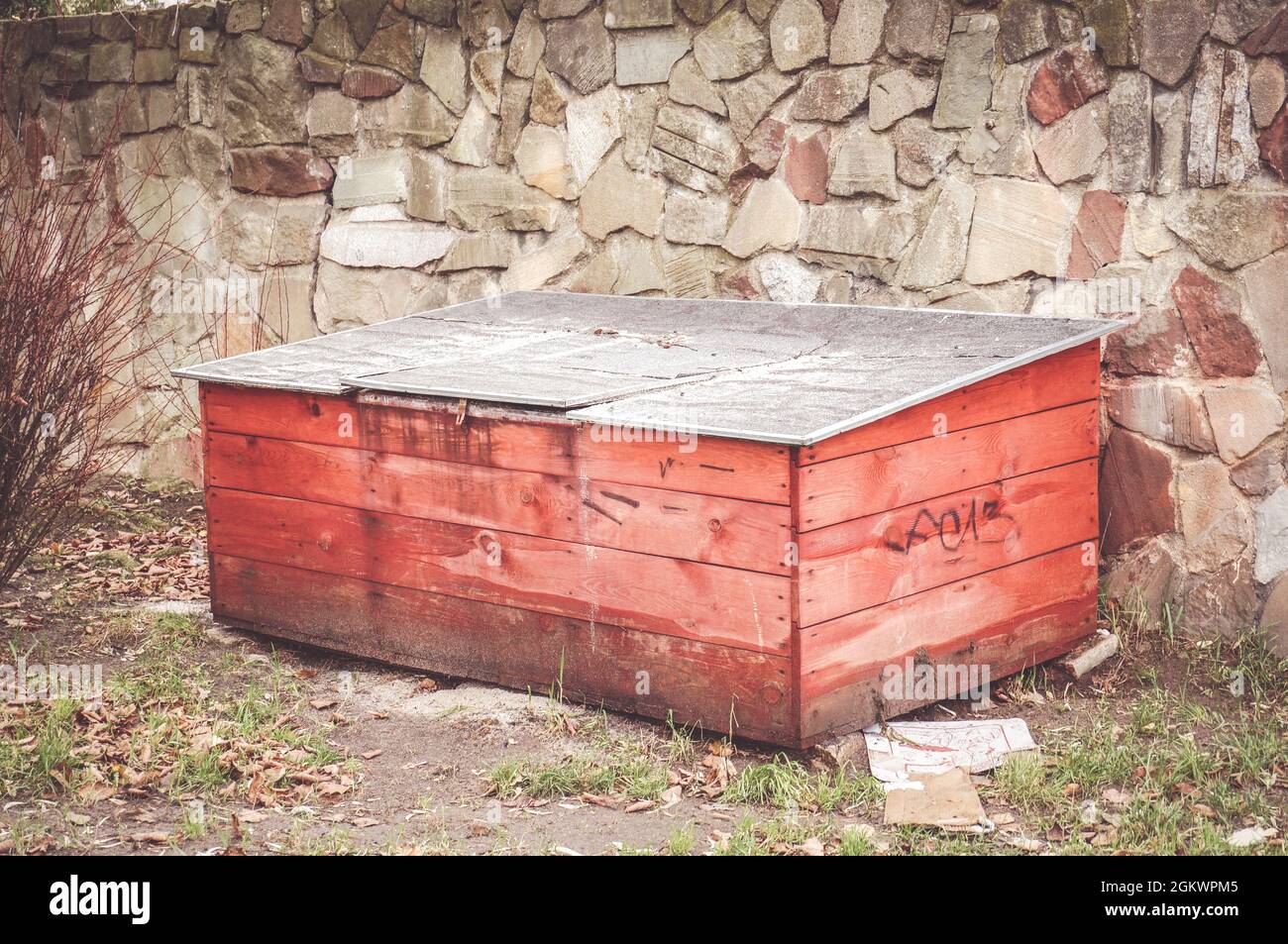 Old wooden box isolated on the ground by the stone wall Stock Photo - Alamy