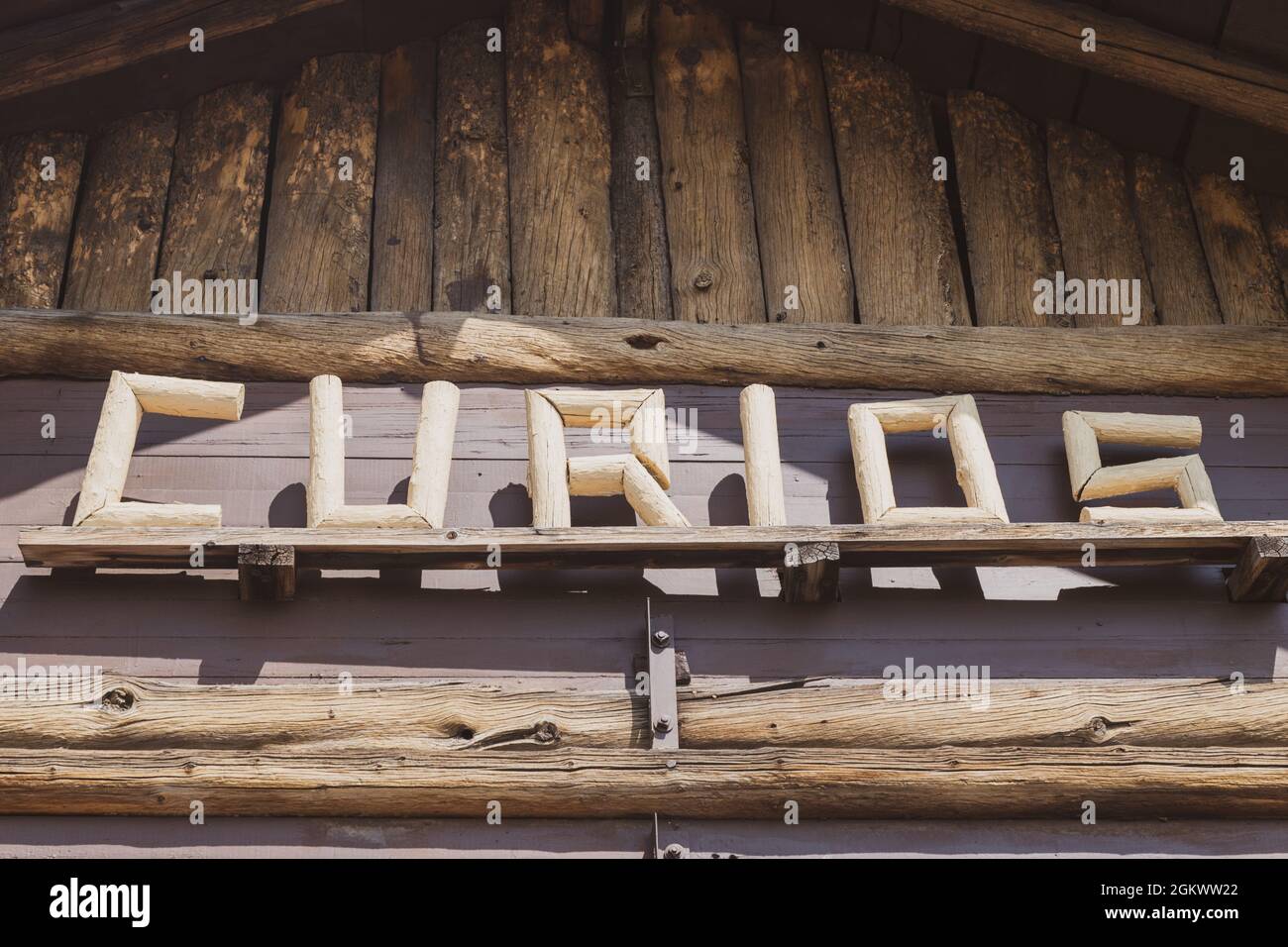 Sign for Curios, written in logs, at a log facade building Stock Photo ...
