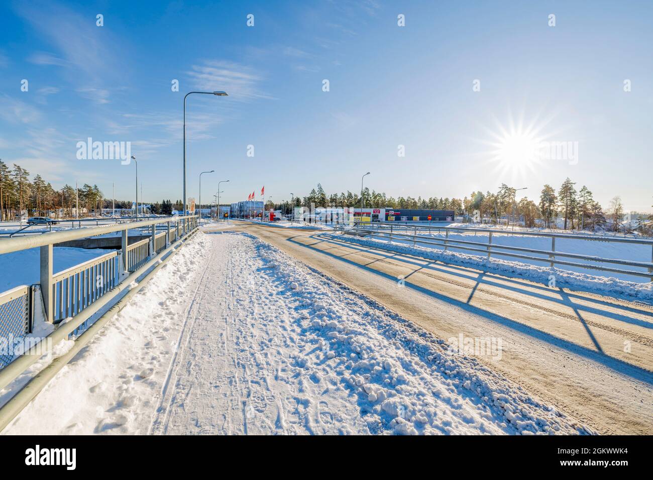 Beautiful winter landscape view. Snowy road merging to blue cloudless ...