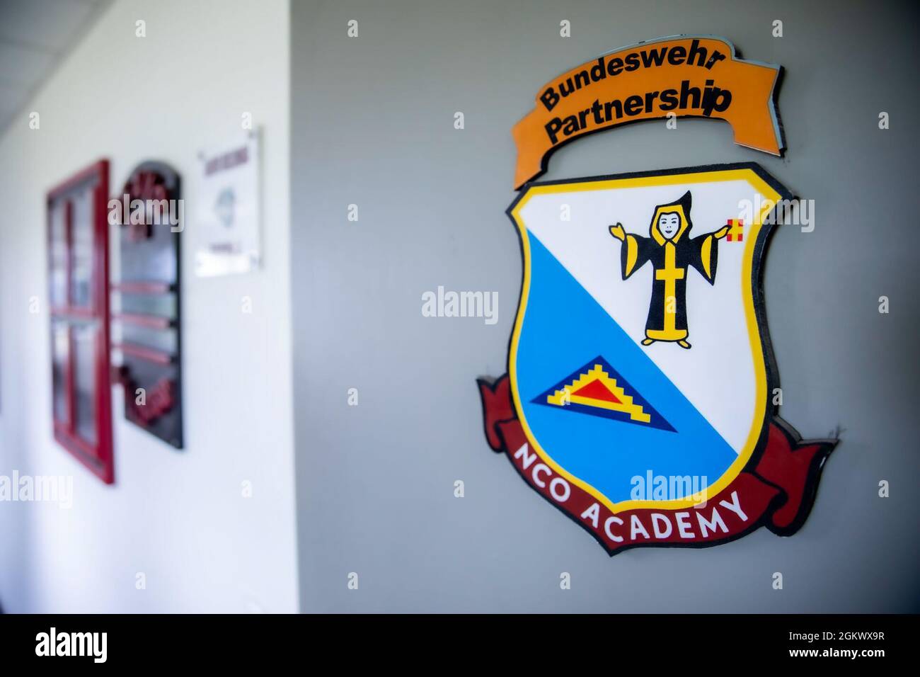 A hand-painted wooden emblem representing the partnership between the ...