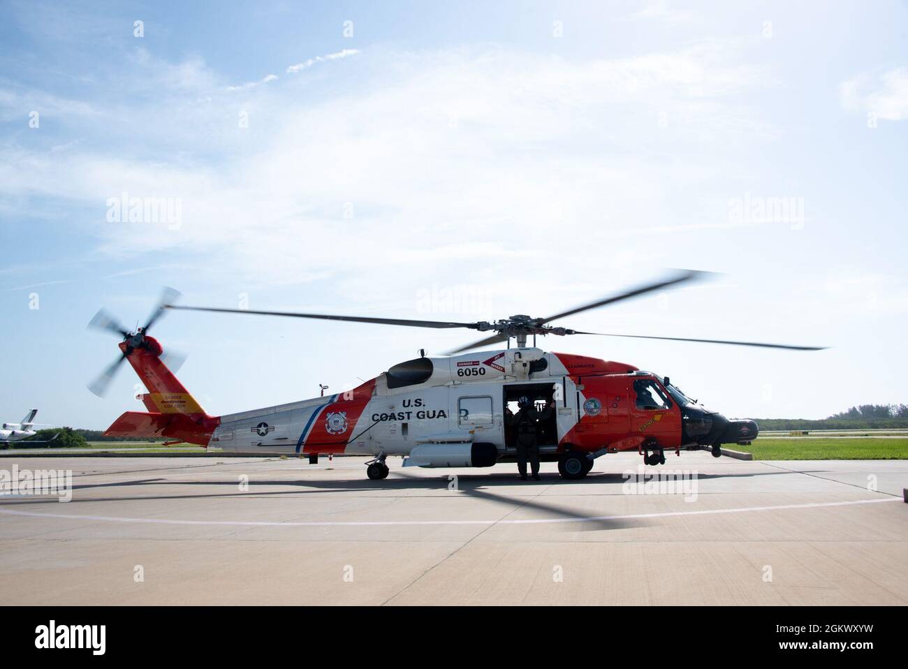 A Coast Guard H-60 Jayhawk helicopter crew prepares to take off from ...
