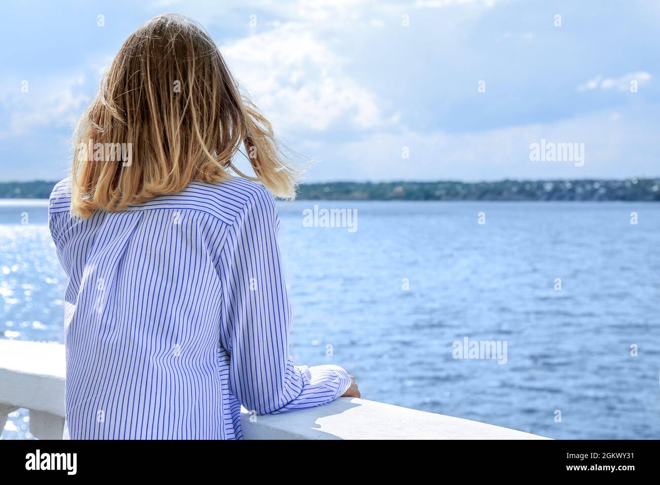 Beautiful young woman relaxing near river Stock Photo - Alamy