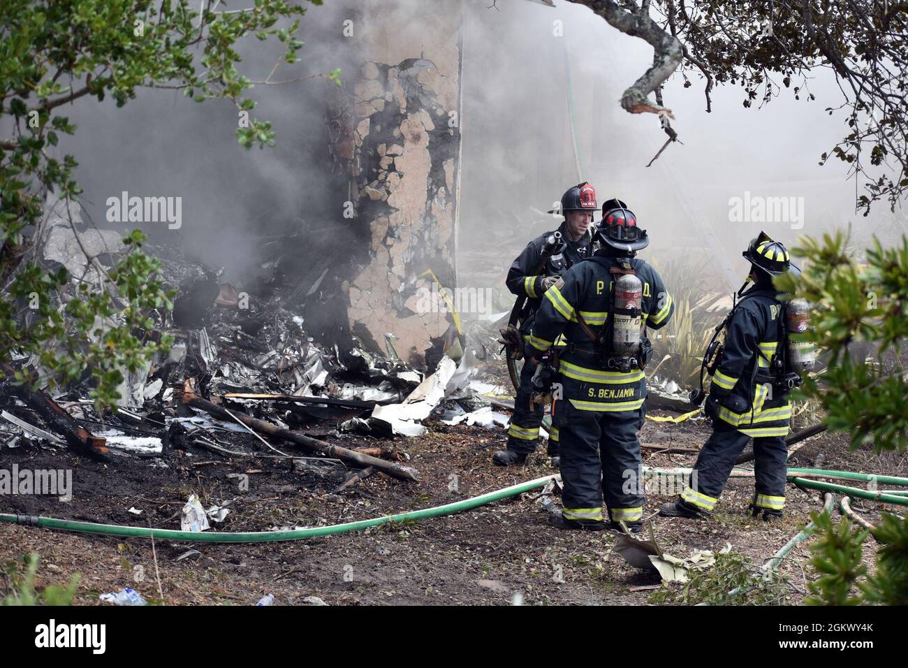 Firefighters with the Presidio of Monterey Fire Department work at the ...