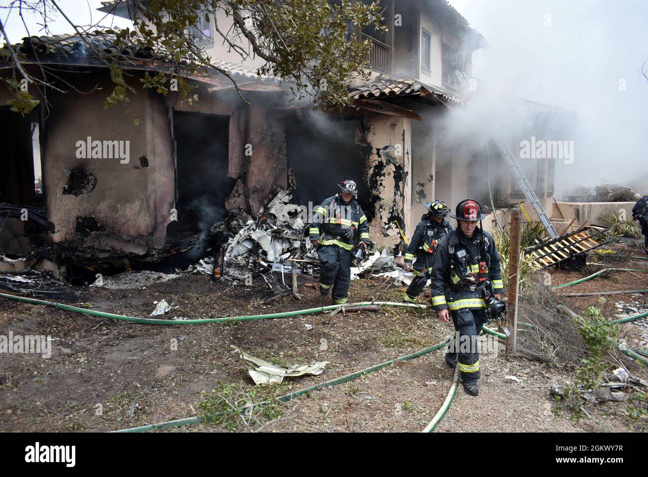 Firefighters with the Presidio of Monterey Fire Department work at the ...