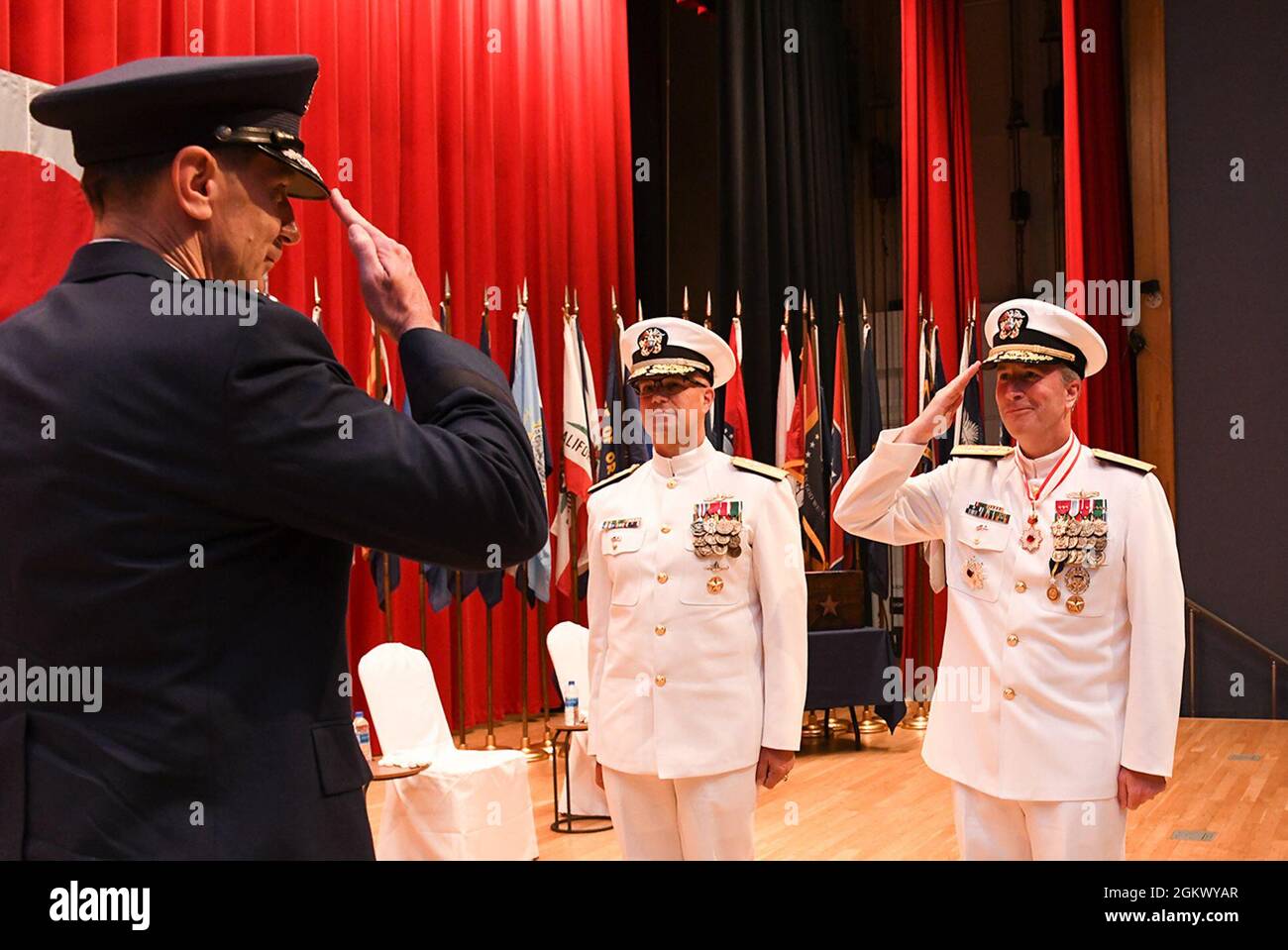Rear Adm. Brian P. Fort (right) salutes Lt. Gen. Kevin B. Schneider ...