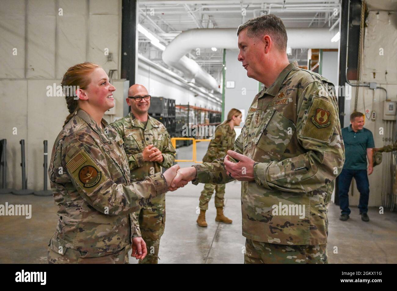 Capt. Megan Shelton (left), 75th Operations Support Squadron, receives ...