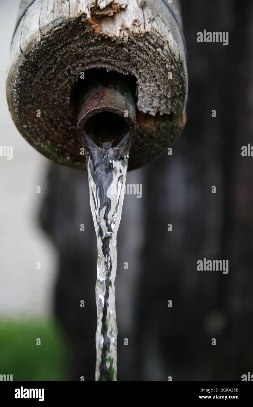 Fresh water from an old fountain Stock Photo - Alamy