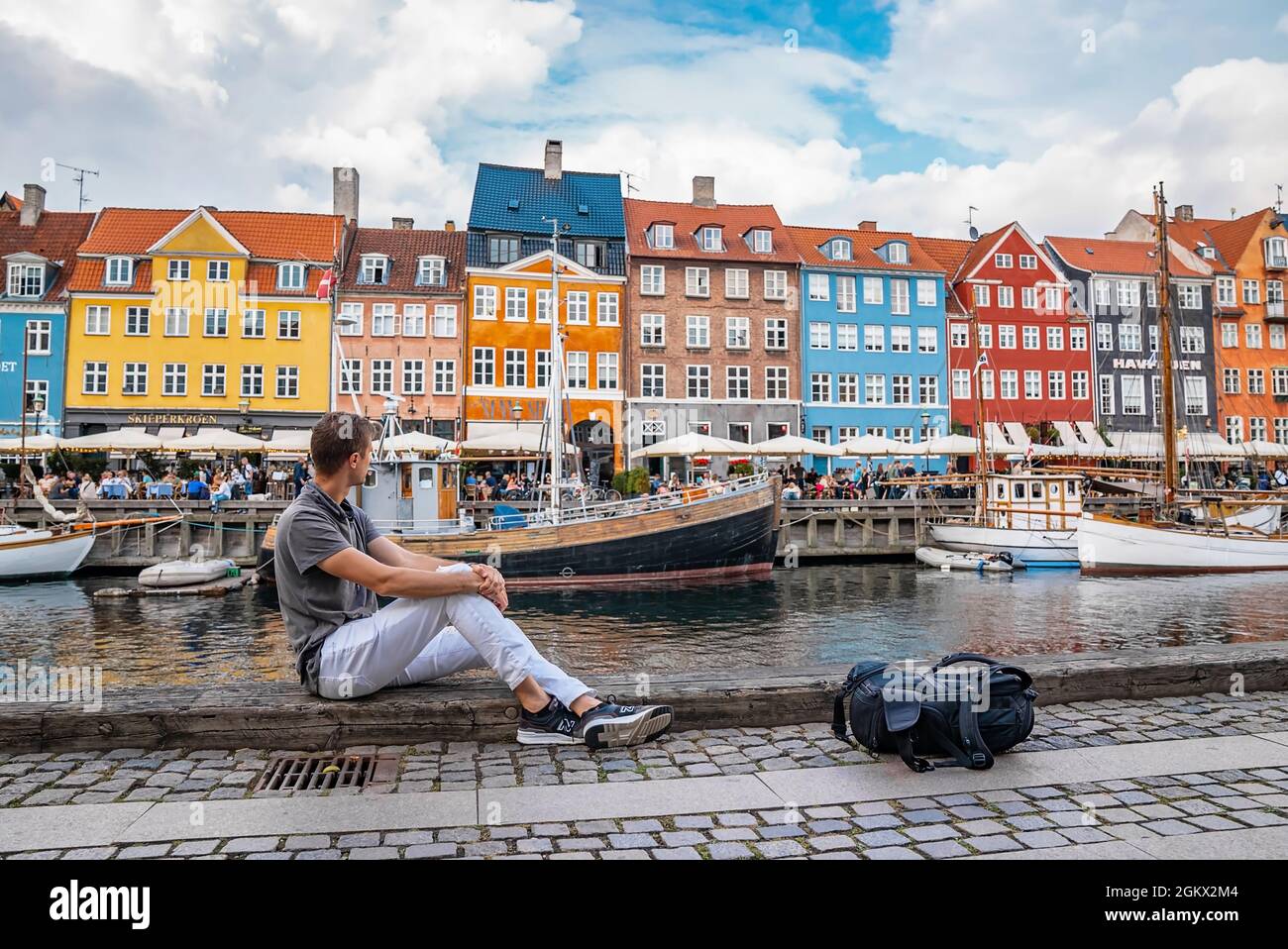Famous Nyhavn pier with colorful buildings and boats in Copenhagen ...