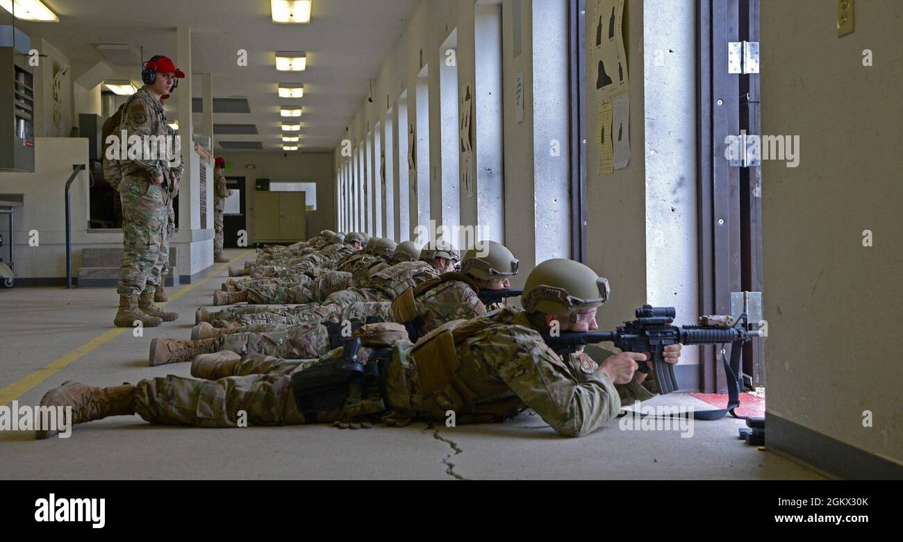 Airmen from the 354th Security Forces Squadron (SFS) fire M4 carbines ...