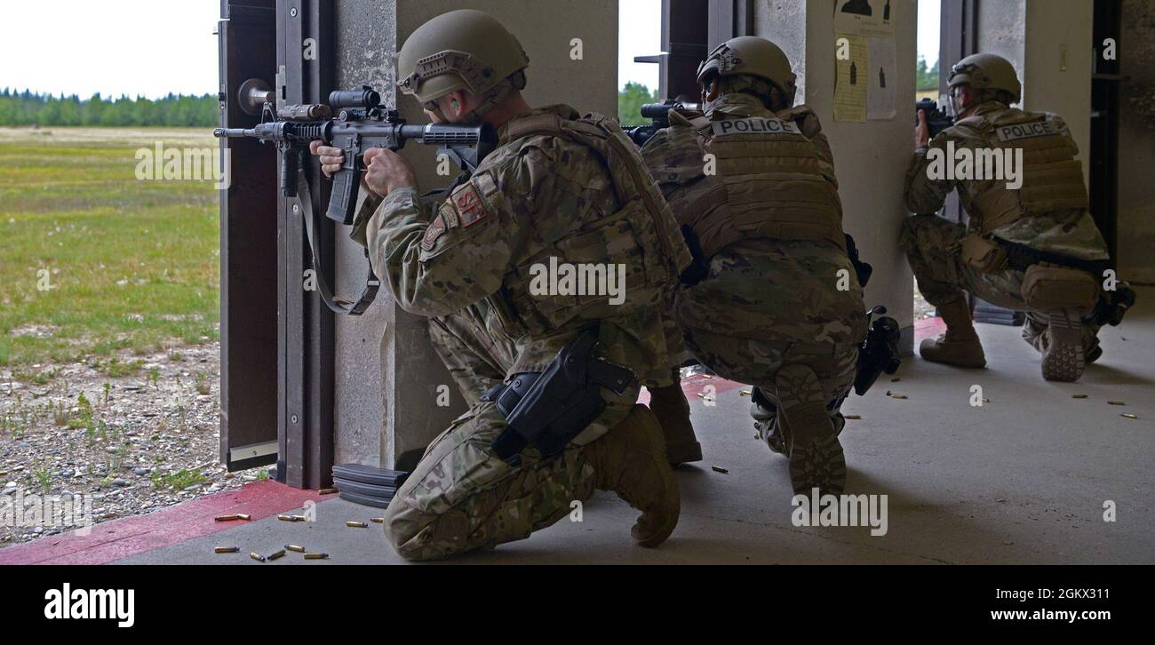 Airmen from the 354th Security Forces Squadron fire M4 carbines from ...