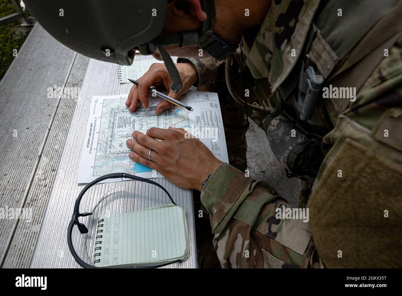 An Officer Candidate examines an area of a topographical line map using ...
