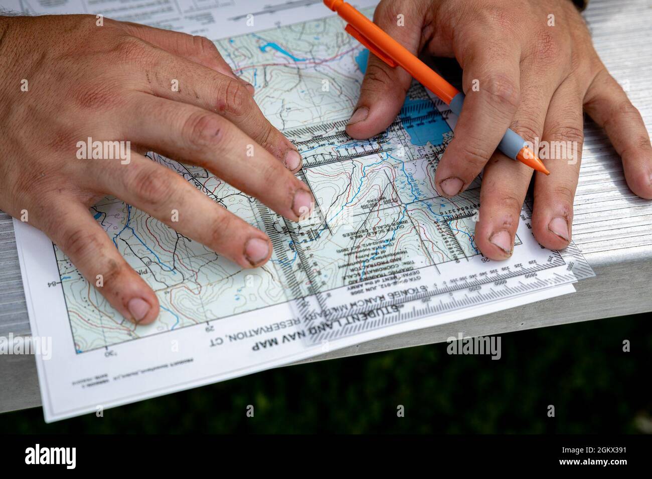 An Officer Candidate examines an area of a topographical line map using ...
