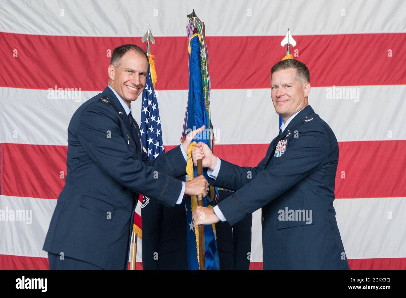 Col. Matthew Husemann, left, 436th Airlift Wing commander passes the ...