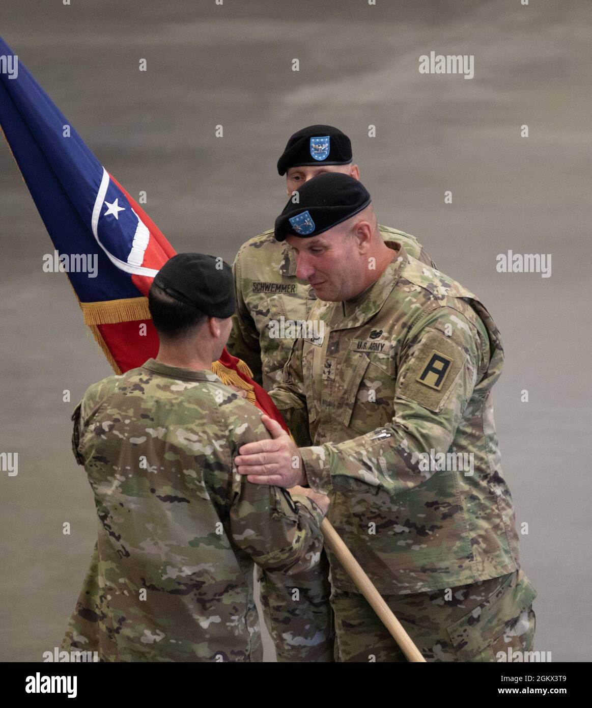 U.S. Army Maj. Gen. Richard F. Johnson passes the colors to Col. Hank ...
