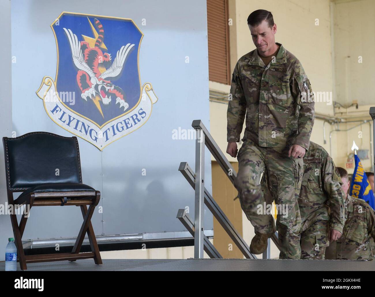 U.S. Air Force Col. Russell P. Cook, 23d Wing commander, leads the official party to the stage ...