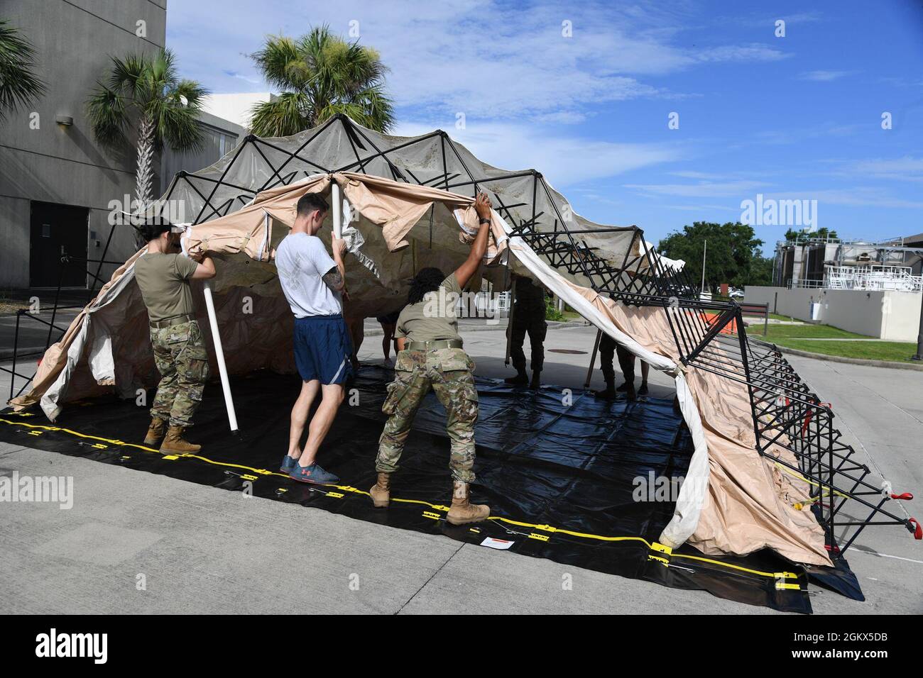 Members of the 81st Medical Group assemble a decontamination tent ...