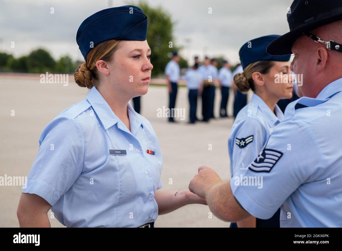 U.S. Air Force Airmen and Space Force Guardians basic military graduation and coining ceremony ...