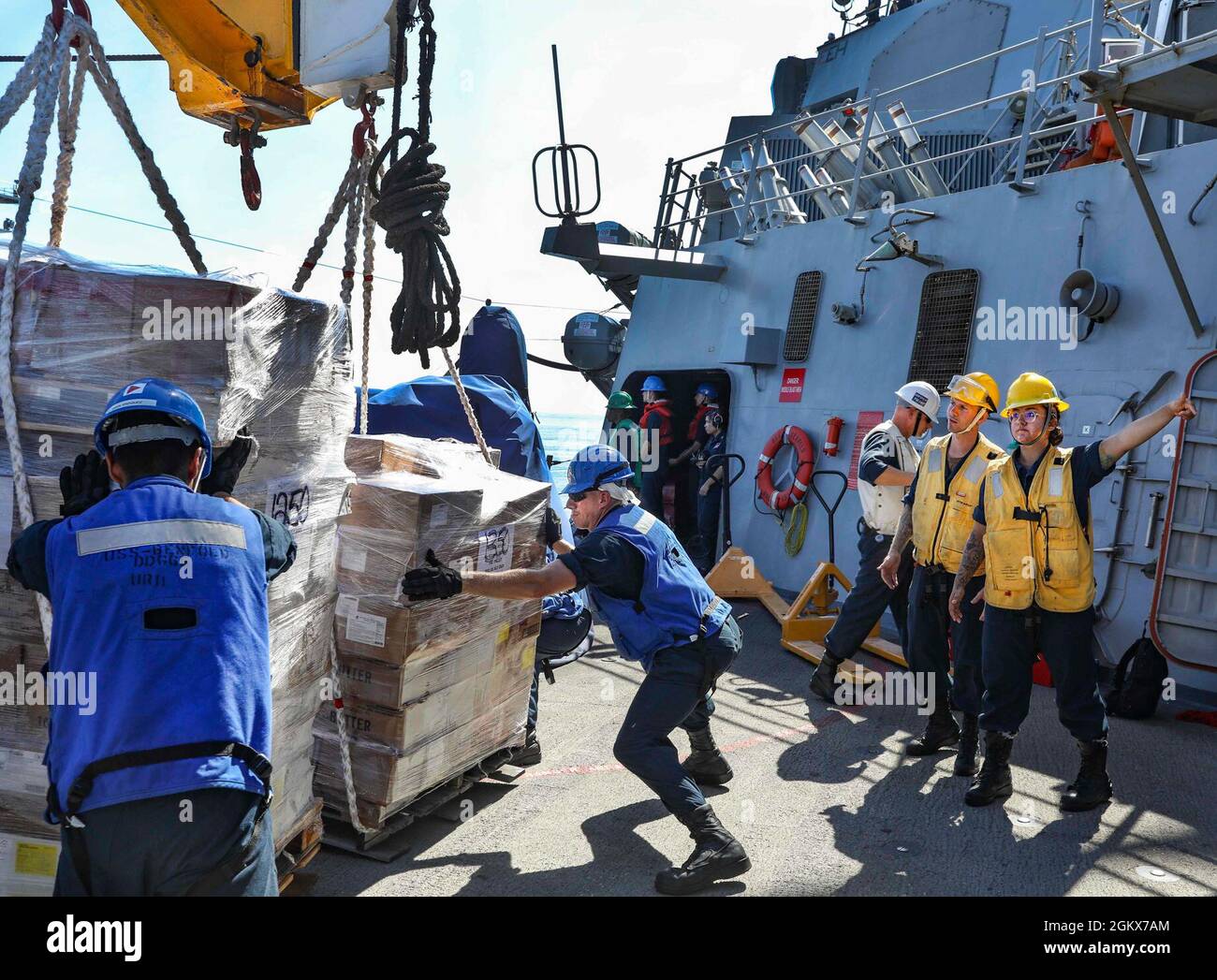 Boatswain’s Mate 3rd Class Nicole Zapata, from Tampa, Fla., signals a ...