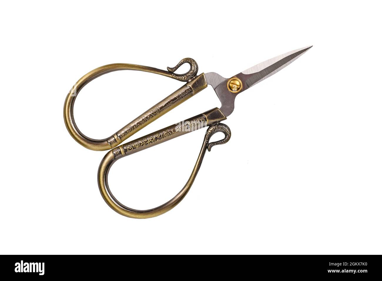 Small golden old fashioned sewing scissors isolated on white background ...