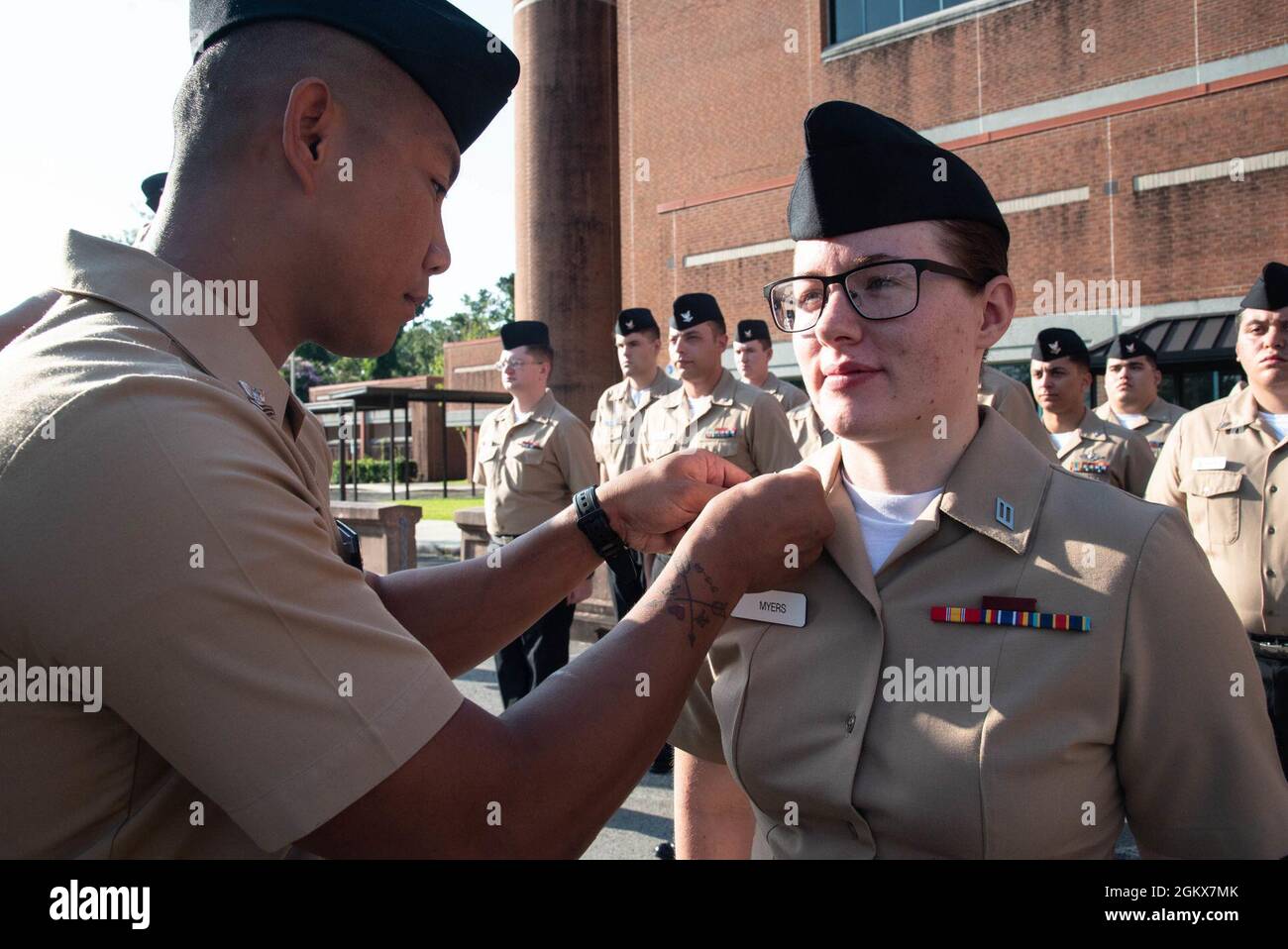A Sailor serving aboard Naval Hospital Cherry Point pins the rank of ...