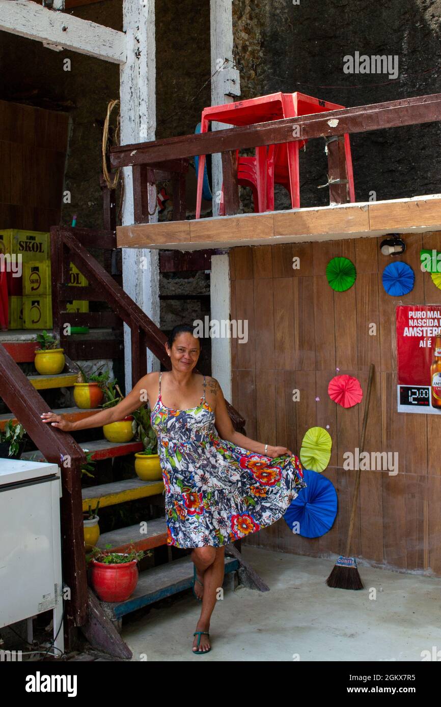 Happy Brazilian woman in private small restaurant in Itaipu Beach, Rio ...